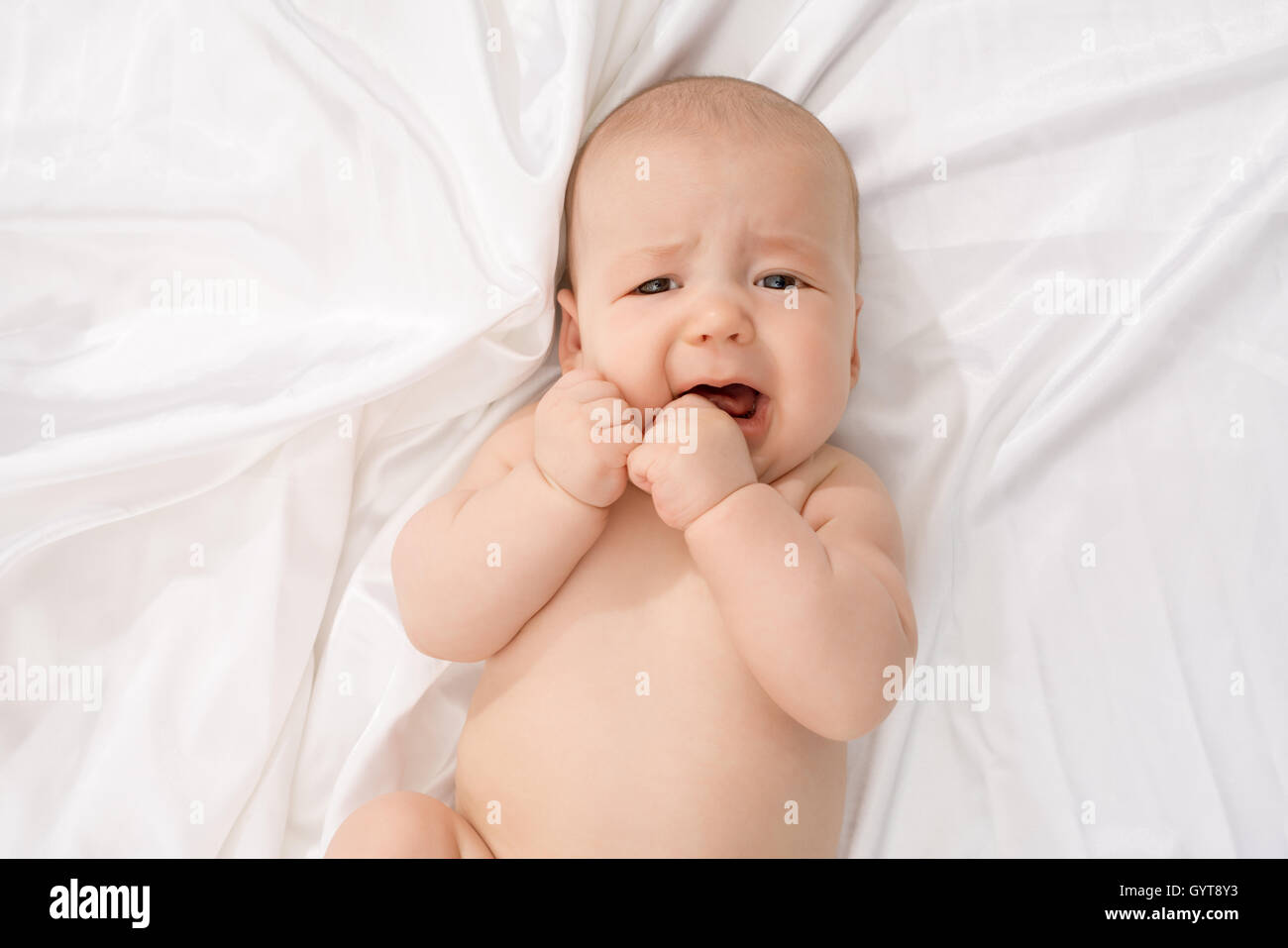 Top view of baby crying while looking at camera Stock Photo - Alamy