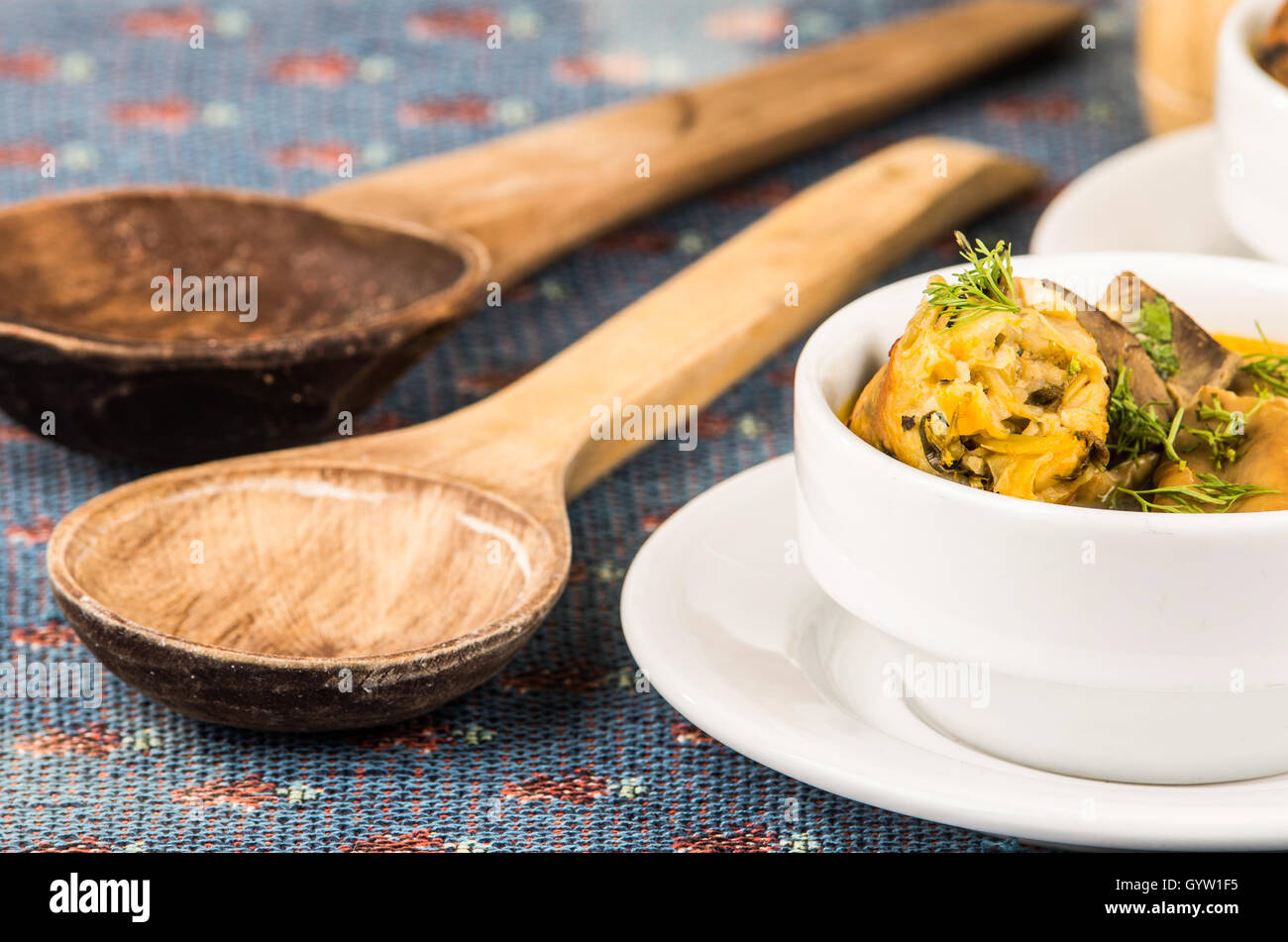 Classy serving of potato soup with meat and vegatables, served in white ...
