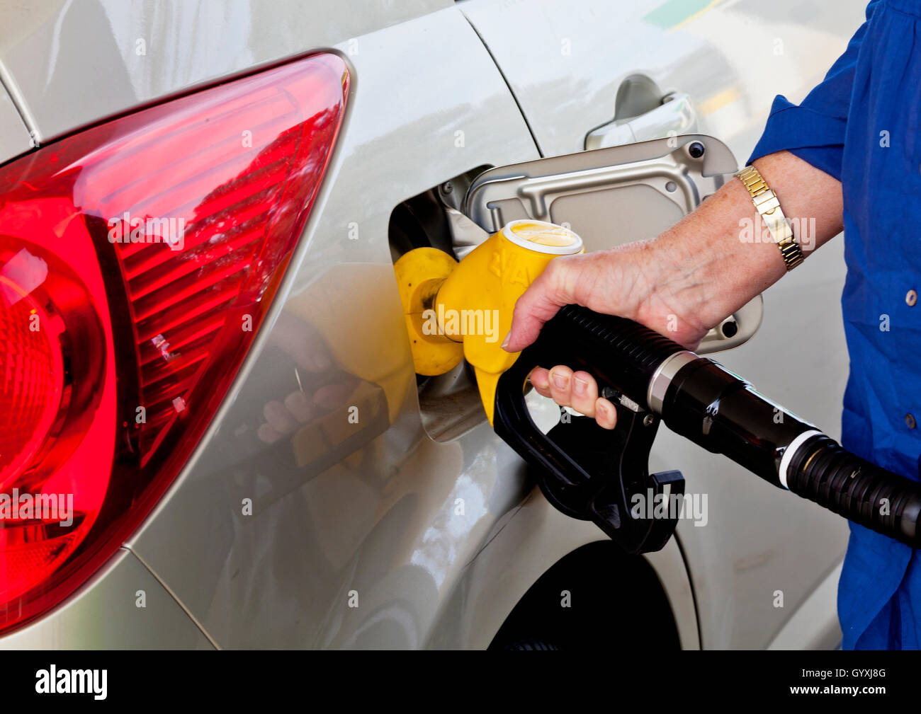 Woman pumping gas fueling car hi-res stock photography and images - Alamy