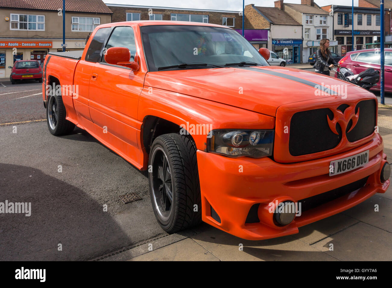 Large bright orange American Style customised pick-up truck parked in ...