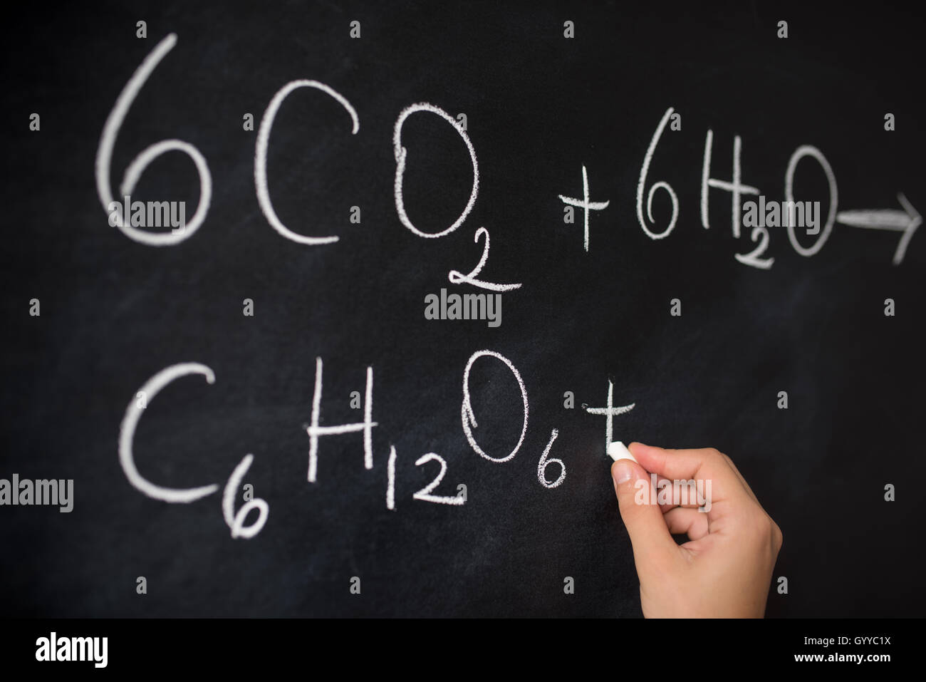 University student writing on blackboard Stock Photo - Alamy