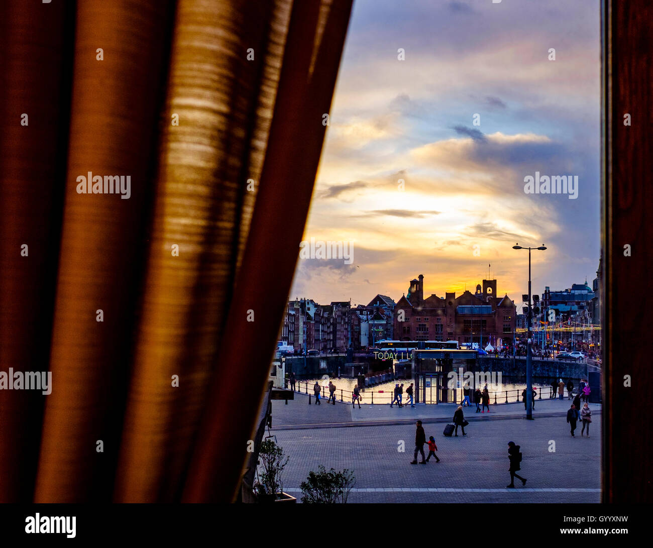 View of the station forecourt through a window with curtain, evening ...