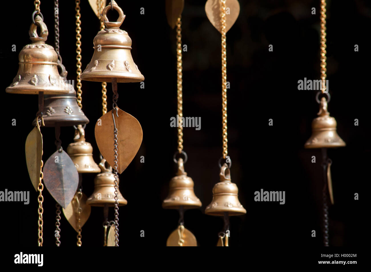 Little praying bells hanging on old temple in Nepal Stock Photo - Alamy