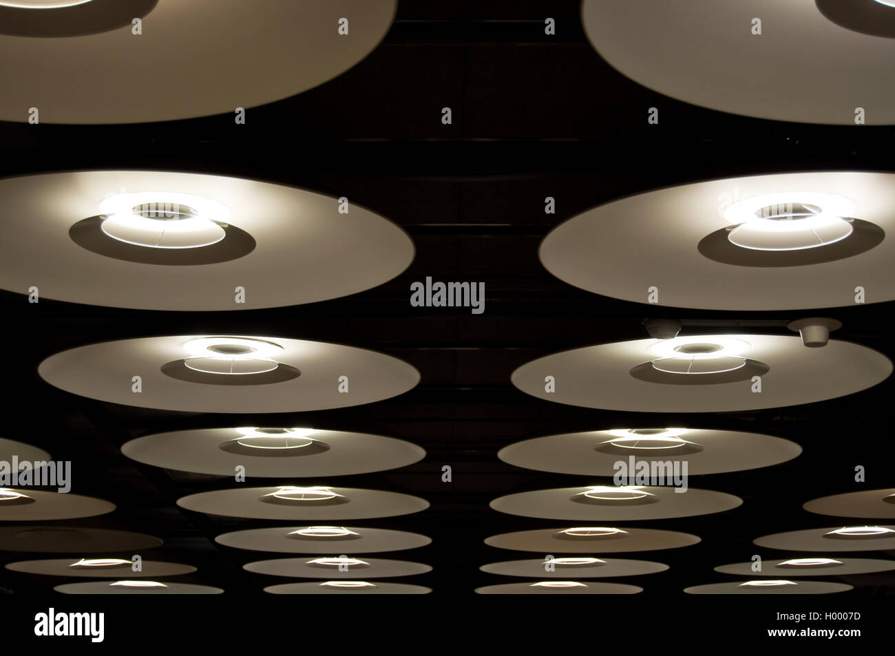 Modern ceiling structure with many circular lamps in Barajas ...