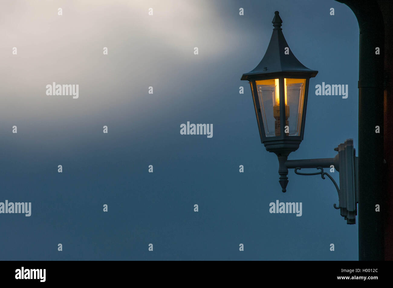 Lantern in foggy twilight village Stock Photo - Alamy