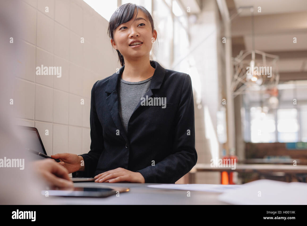 Shot of confident young Asian business woman giving presentation to ...