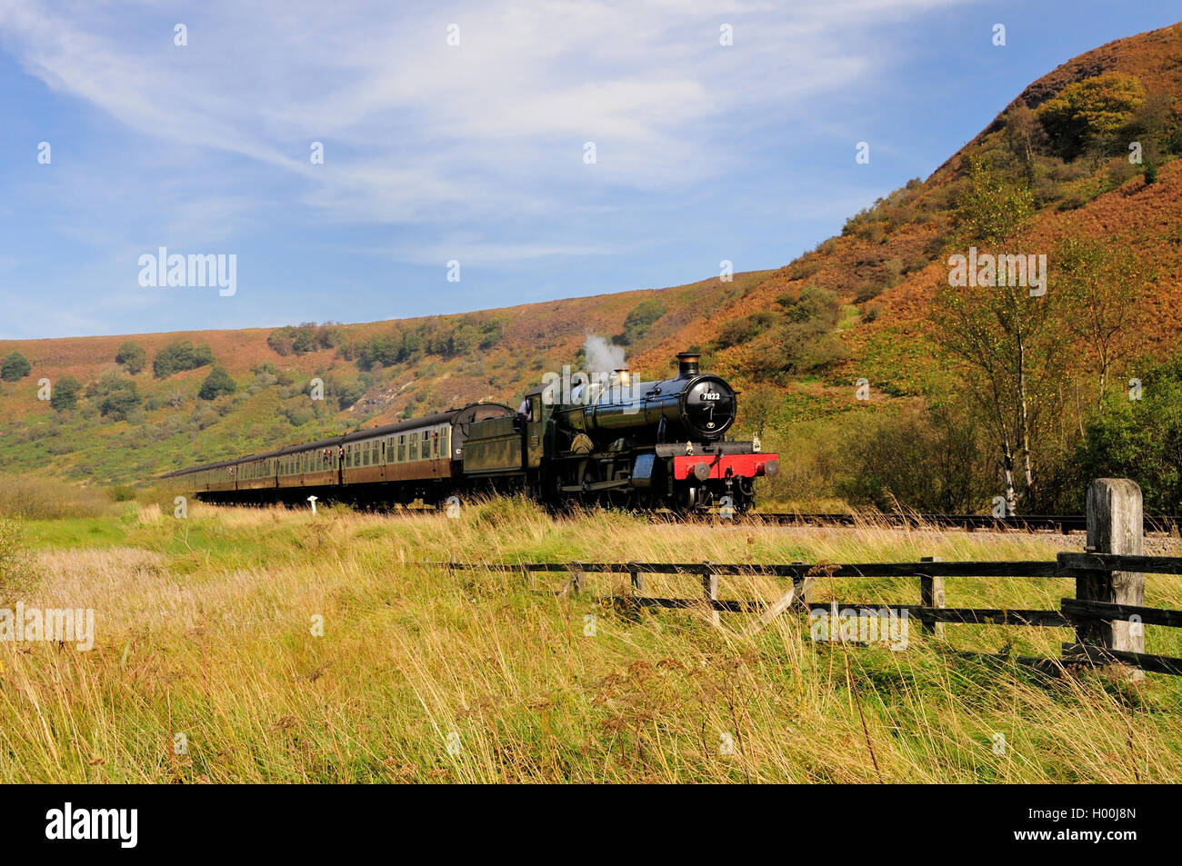 Steam train hauled by GWR loco No 7822 "Foxcote Manor" passing through ...
