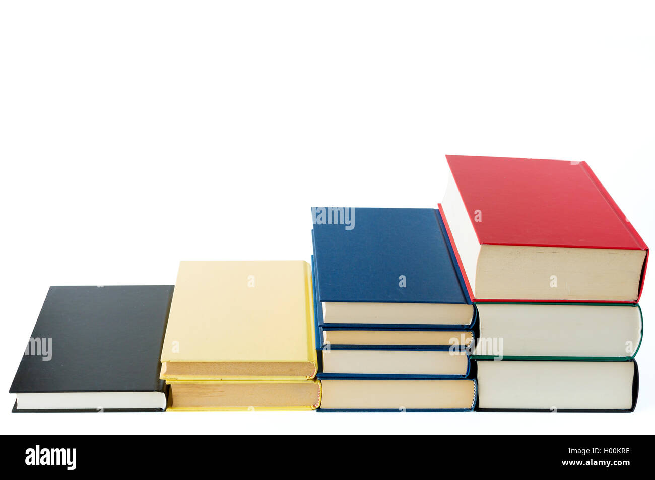 Stairs of books closeup isolated on white Stock Photo - Alamy