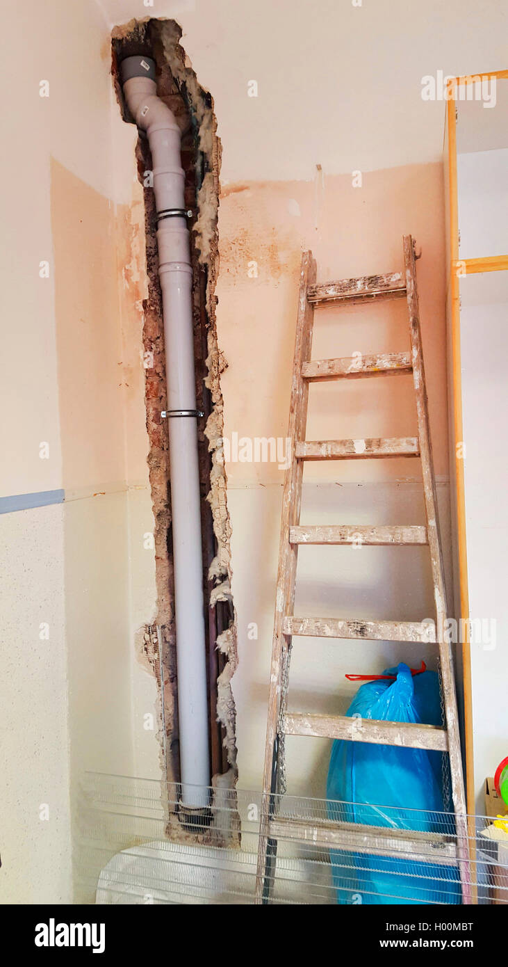 open wall with replaced wastewater pipe, Germany Stock Photo - Alamy