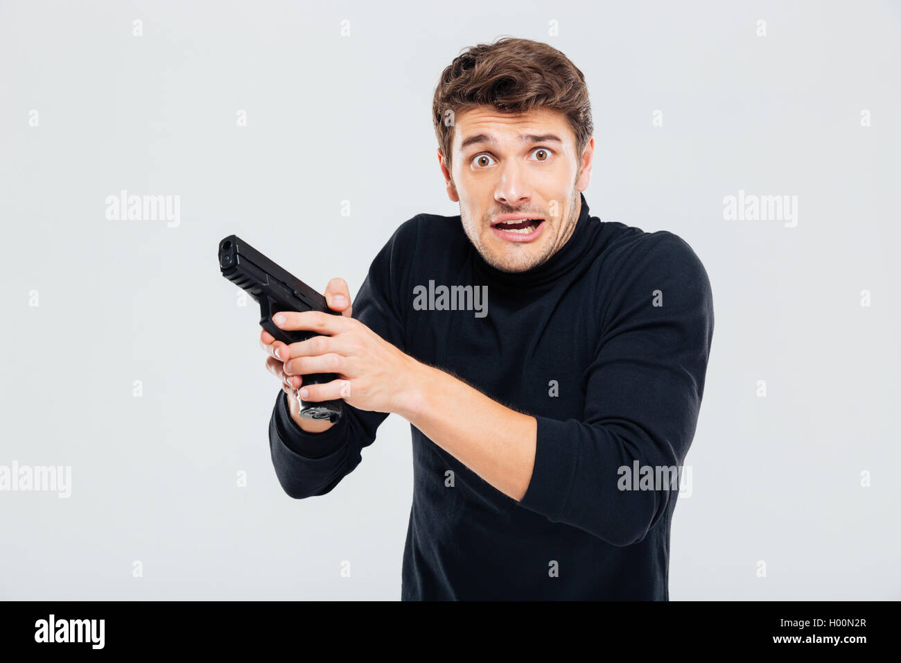 Man holding a gun hi-res stock photography and images - Alamy