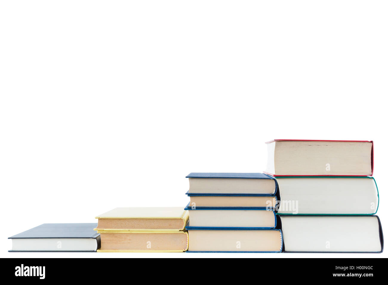 Stairs of books closeup isolated on white Stock Photo - Alamy