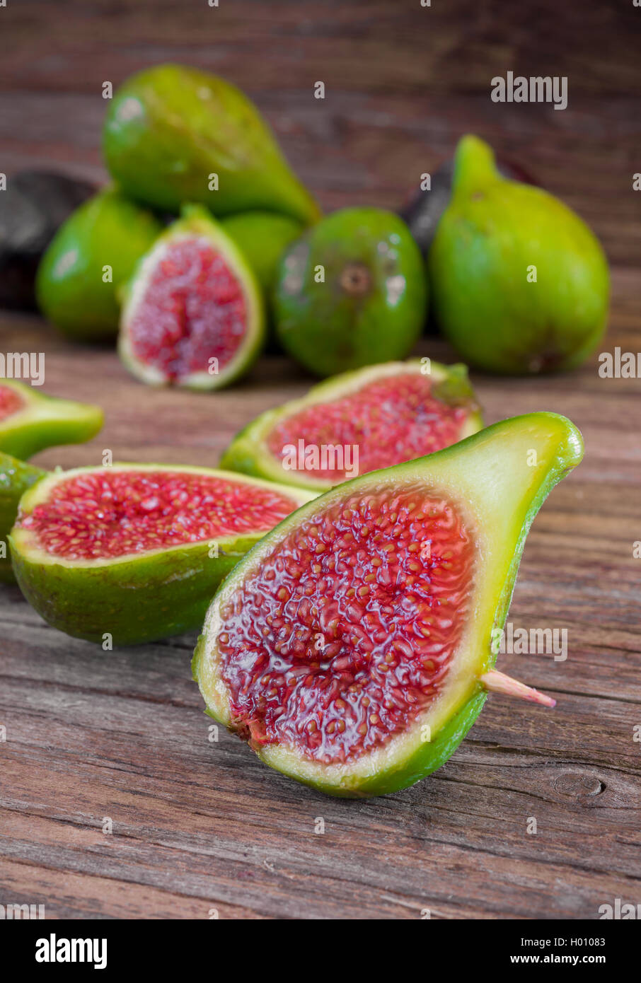 green natural figs sliced on wooden table Stock Photo - Alamy
