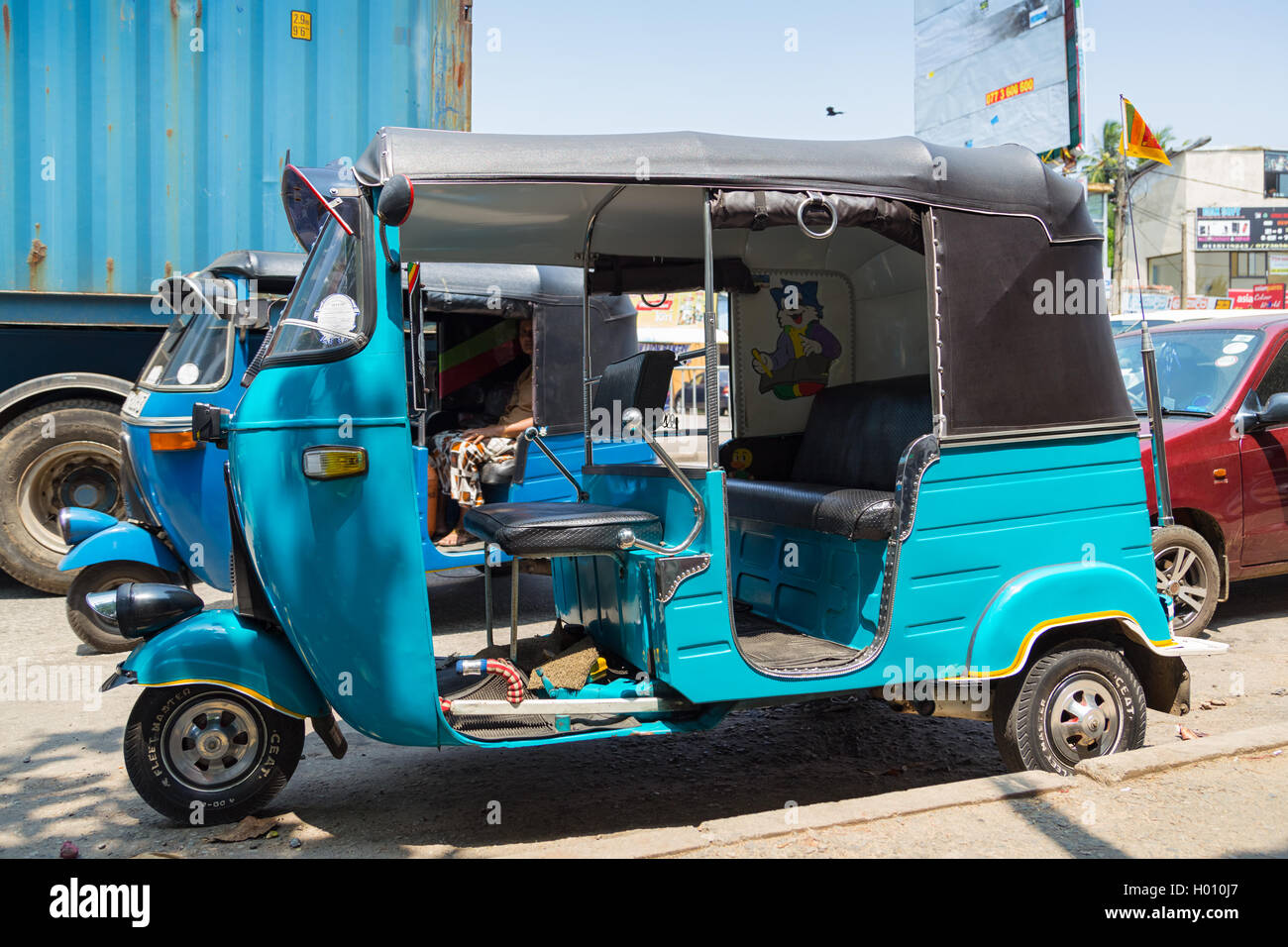 HIKKADUWA, SRI LANKA - FEBRUARY 22, 2014: Blue tuk-tuk vehicle parked ...