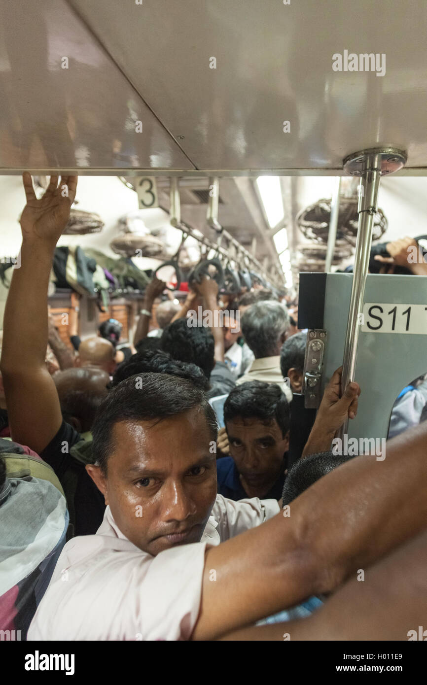 HIKKADUWA, SRI LANKA - FEBRUARY 22, 2014: Local men in the train ...