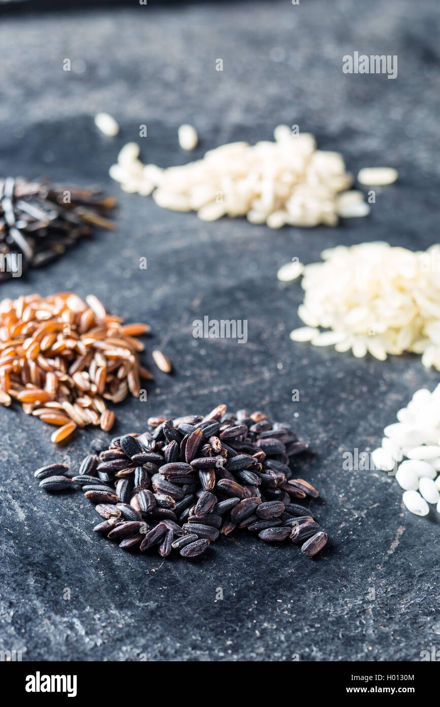 Different rice varieties on old table Stock Photo - Alamy