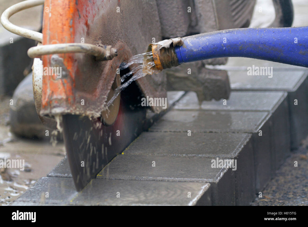 cutting paving blocks with angle grinder Stock Photo - Alamy