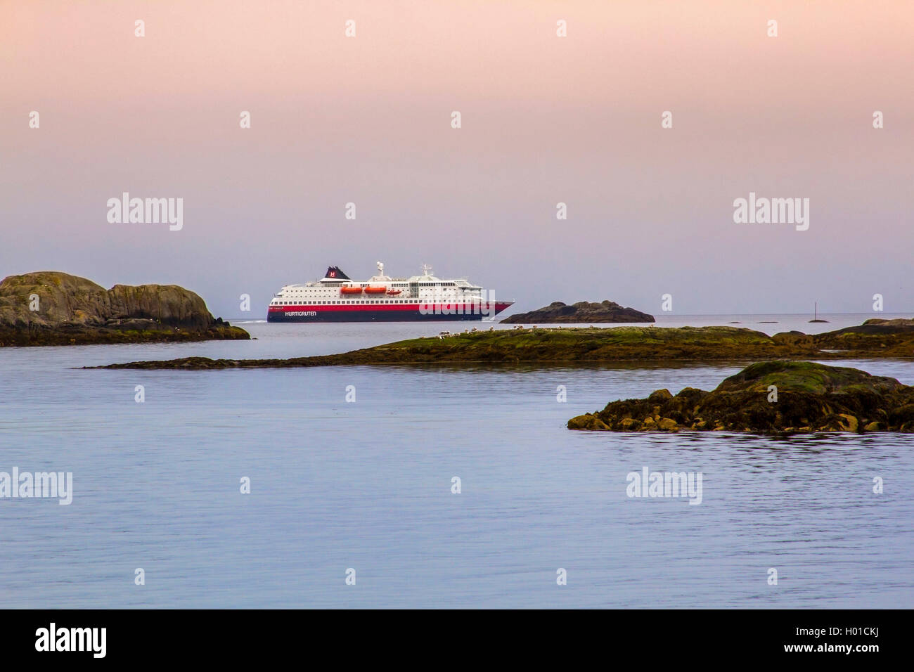 a ship of the Hurtigruten passes the Lofotes, Norway, Lofoten Islands ...