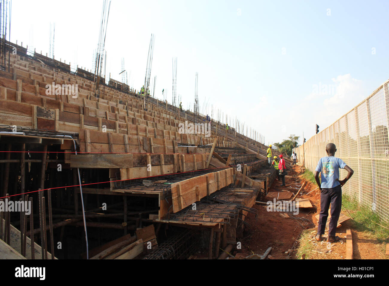 Workers constructing a sports stadium in Wakiso district in Uganda ...