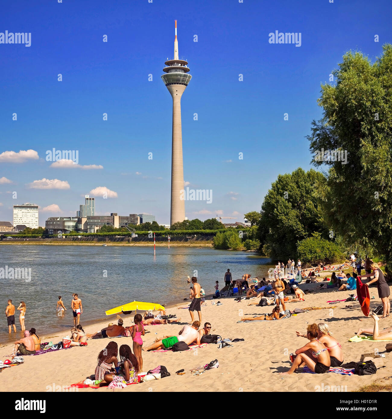 people at the beach of the Rhine with the Rhine tower, Germany, North ...