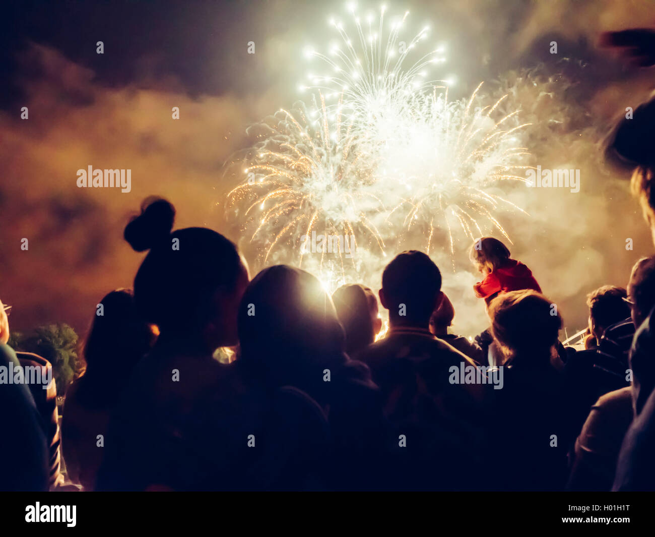 Crowd wathcing fireworks and celebrating Stock Photo - Alamy