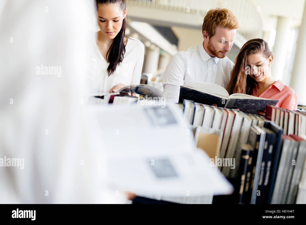 Group of students studying in library and reading books Stock Photo - Alamy