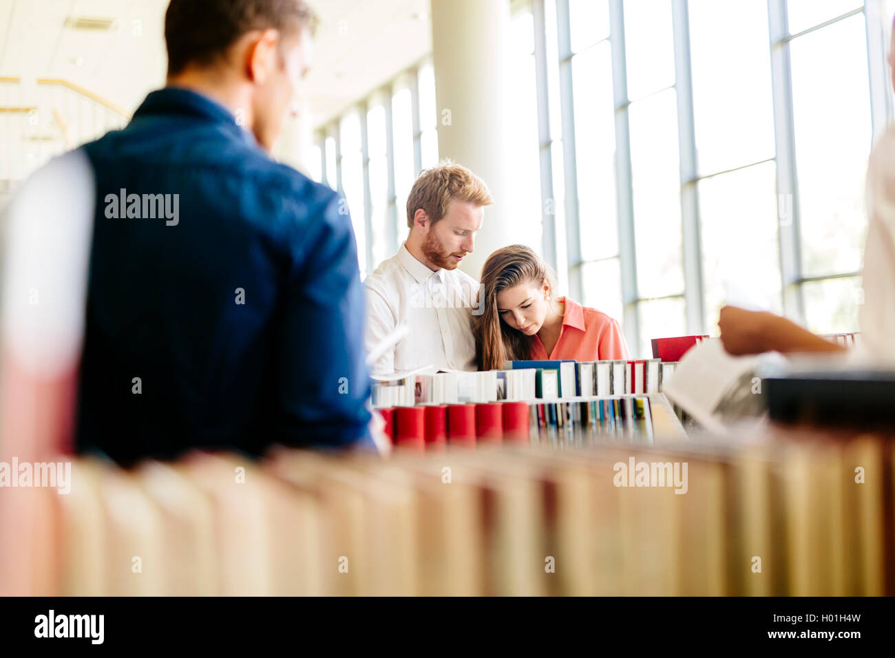 Group of students studying in library and reading books Stock Photo - Alamy