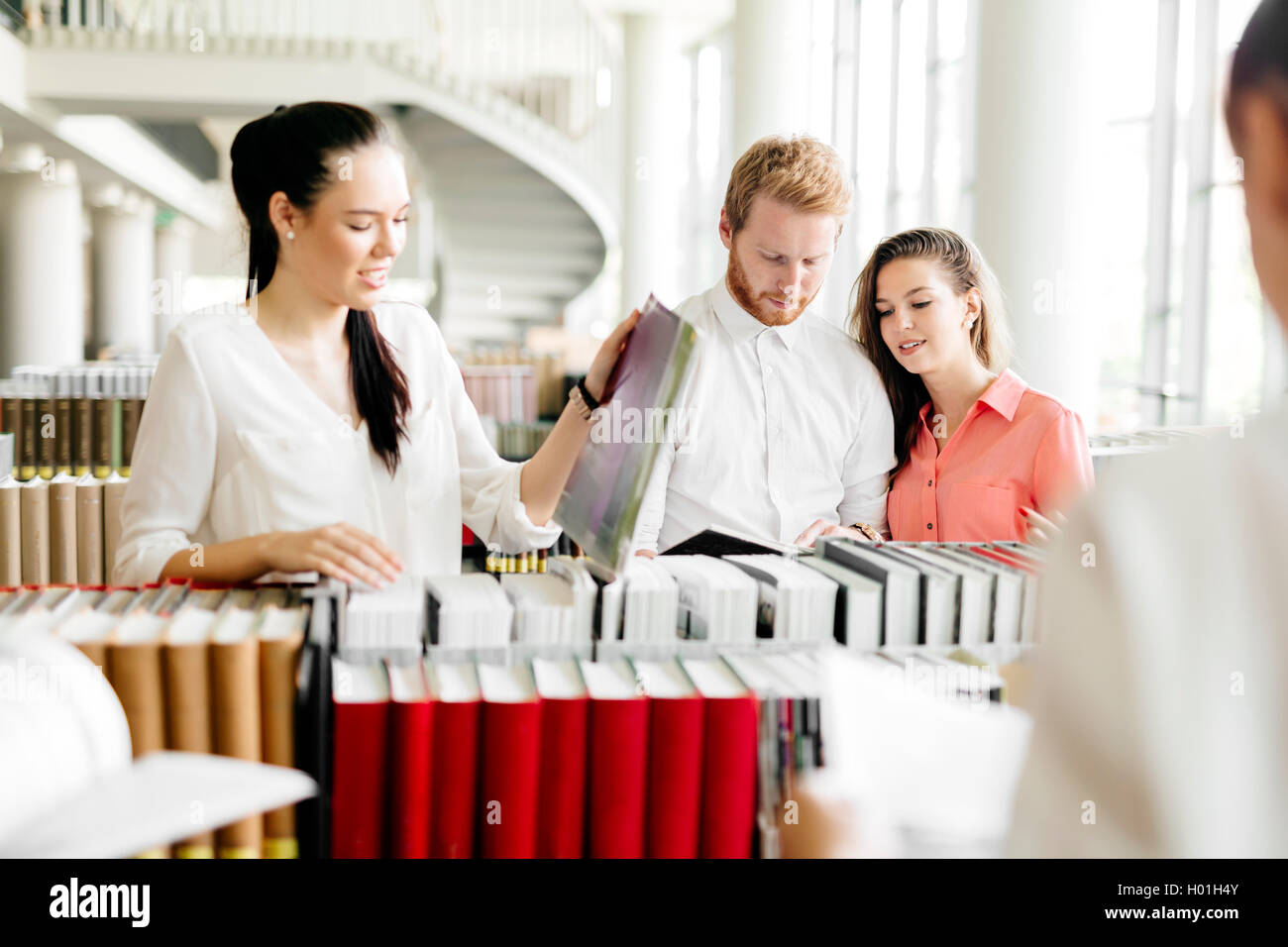 Group of students studying in library and reading books Stock Photo - Alamy