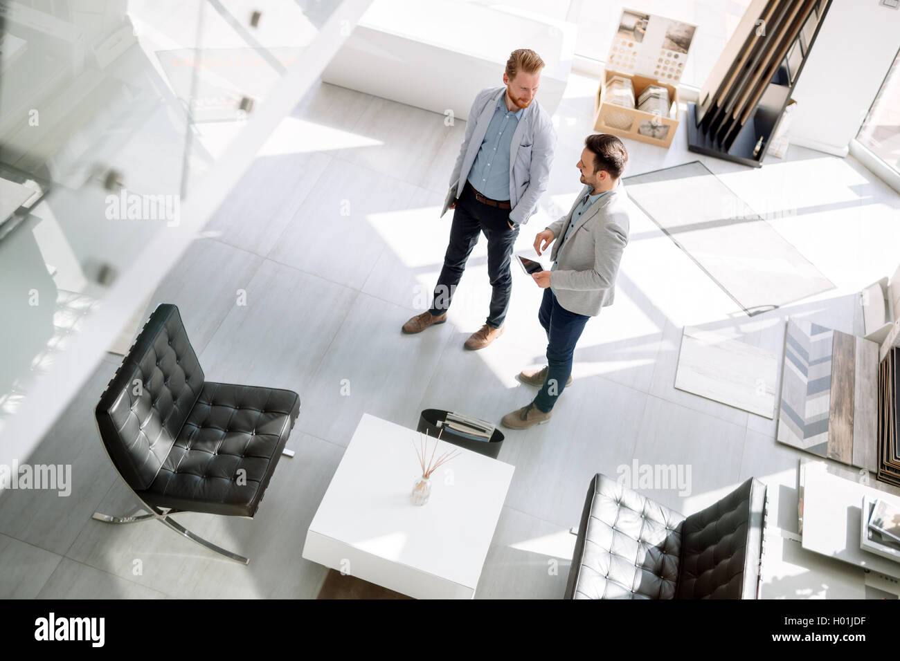 Two customers entering interior design store Stock Photo - Alamy