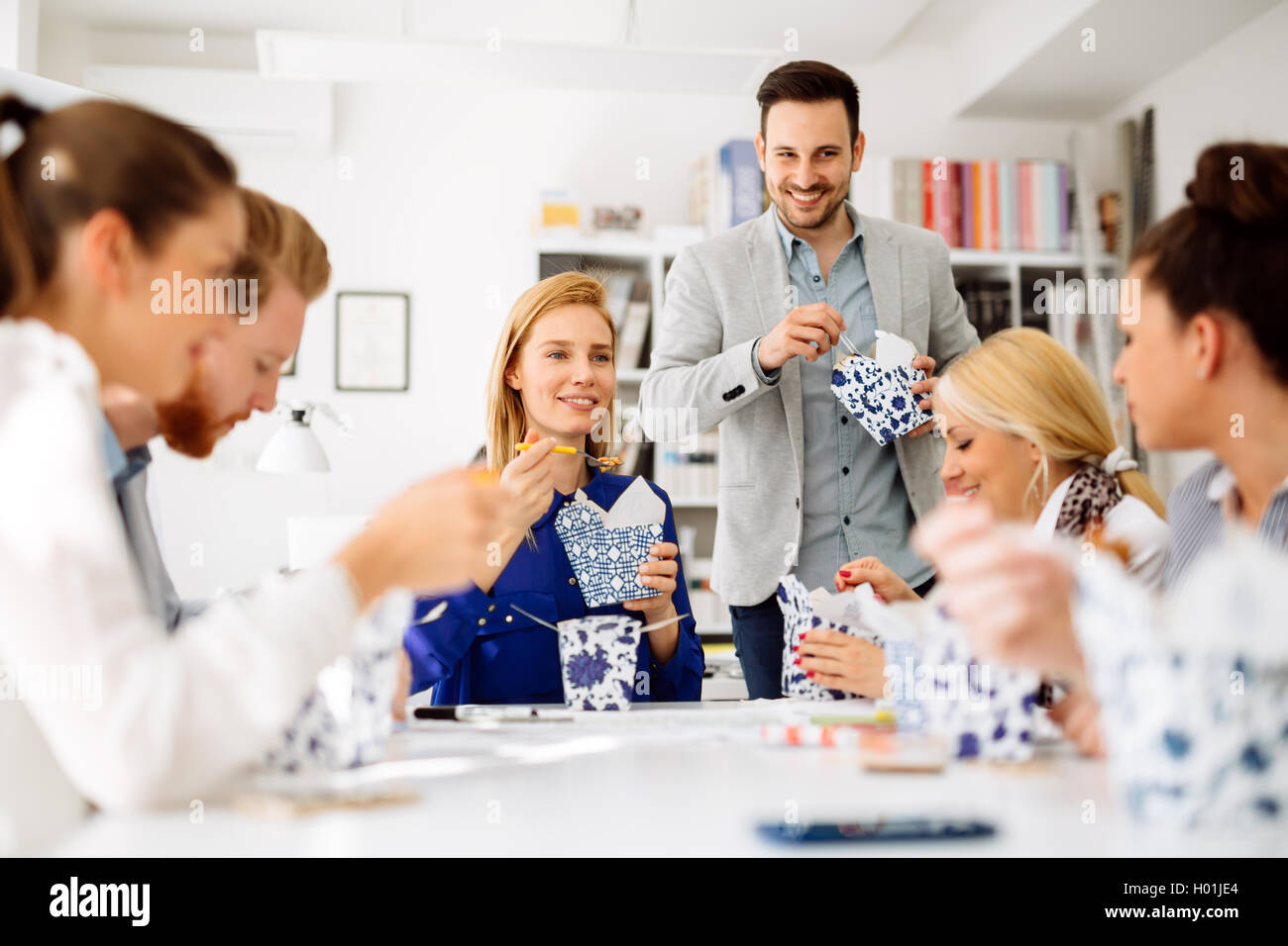 Business people eating meals in office Stock Photo - Alamy