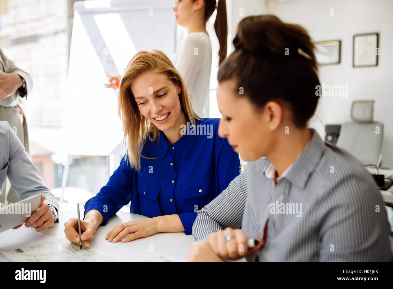 Succeful business partners brainstorming in office Stock Photo - Alamy