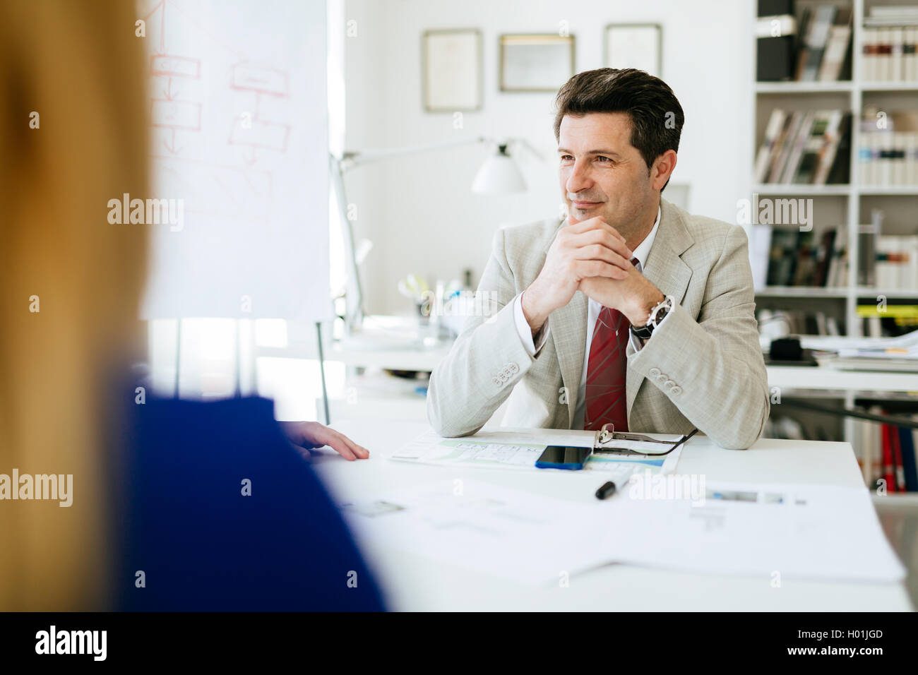 Company director sitting at table thinking about future plans Stock ...