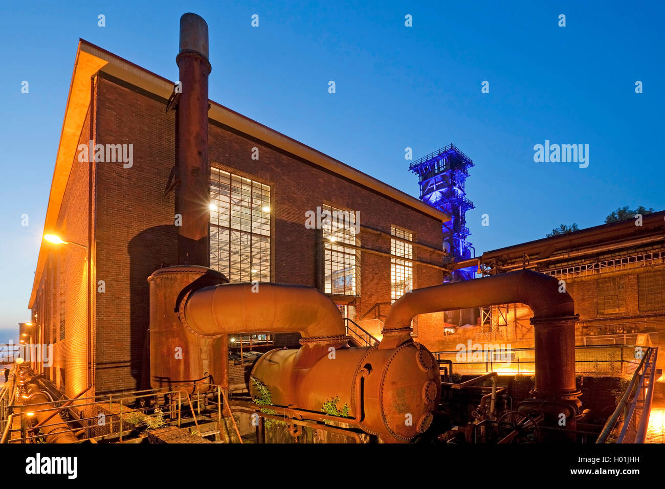 illuminated former compressor hall and cooling tower of coking plant ...