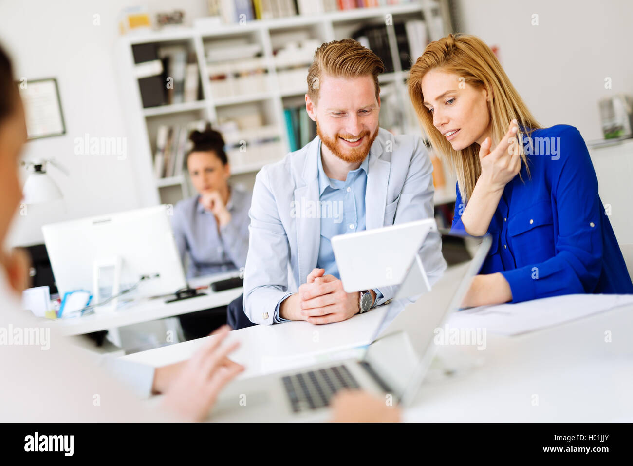 Successful business partners brainstorming in office Stock Photo - Alamy