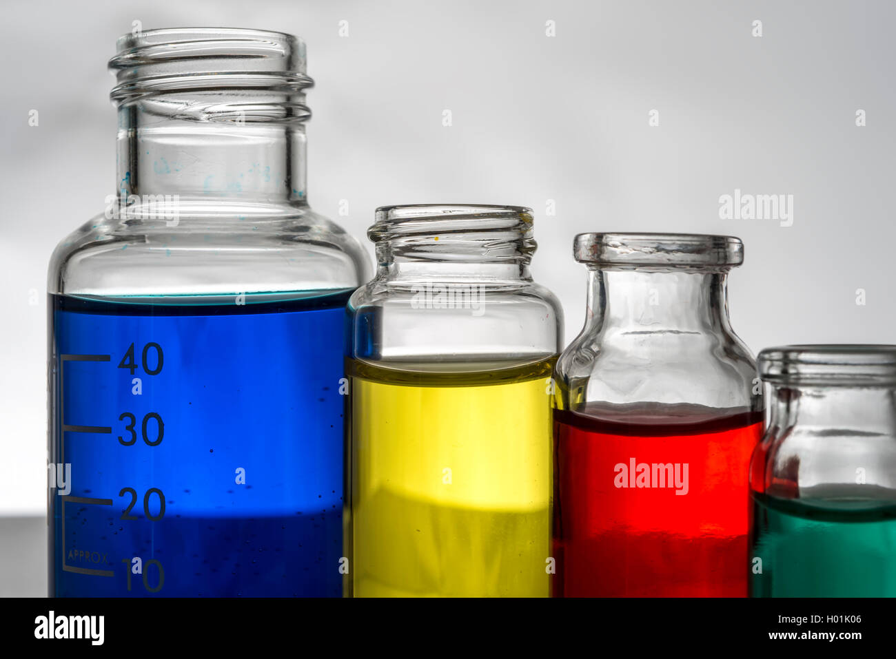 Set of laboratory bottles with color liquid Stock Photo - Alamy