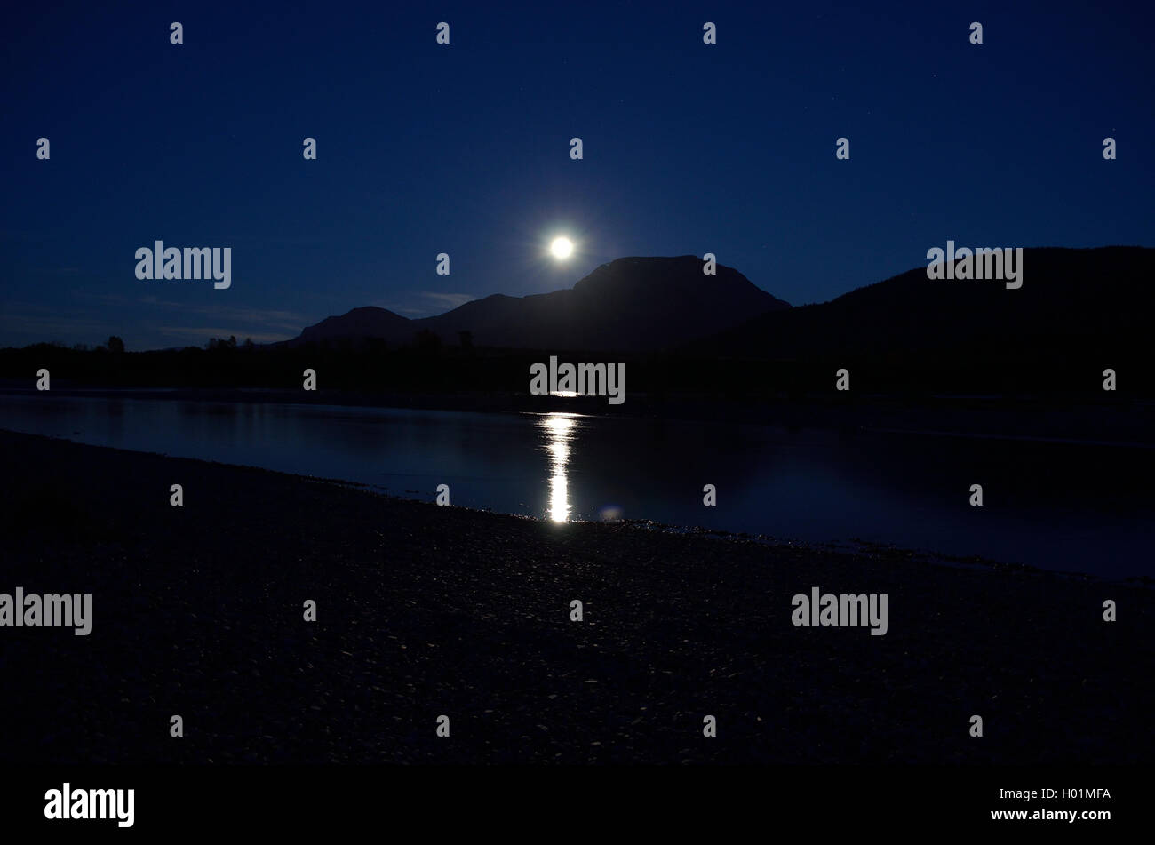 full moon over night mountain with reflection on river surface Stock ...