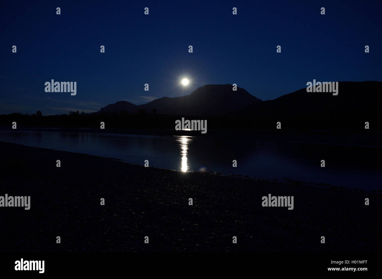 full moon over night mountain with reflection on river surface Stock ...