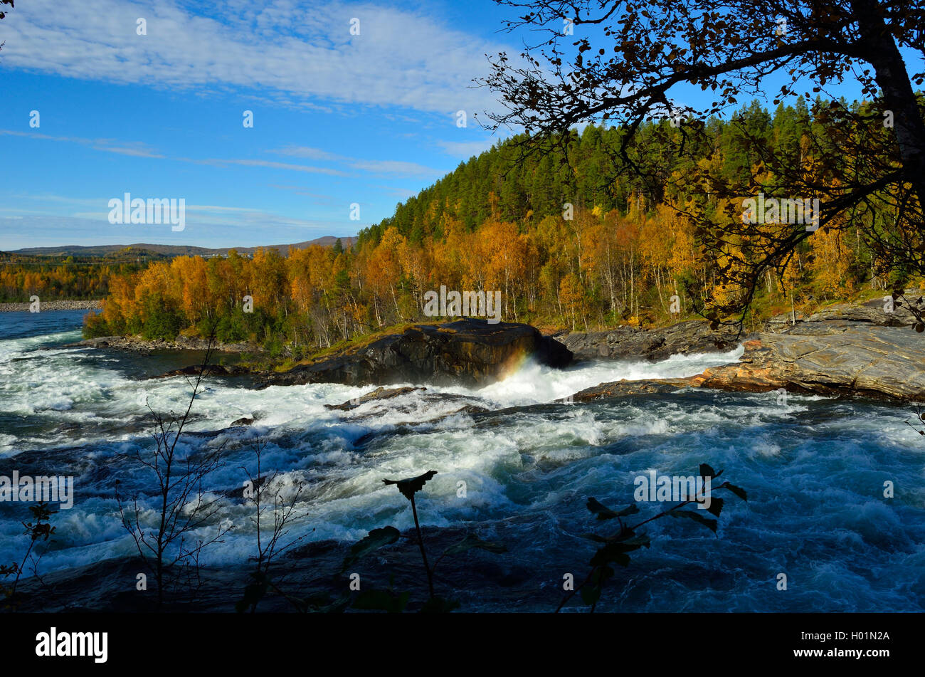 mighty waterfall in autumn with colorful forest and small rainbow ...