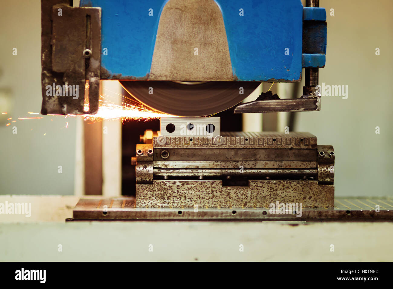 Polishing surface of metal in factory with sparkles showing during ...