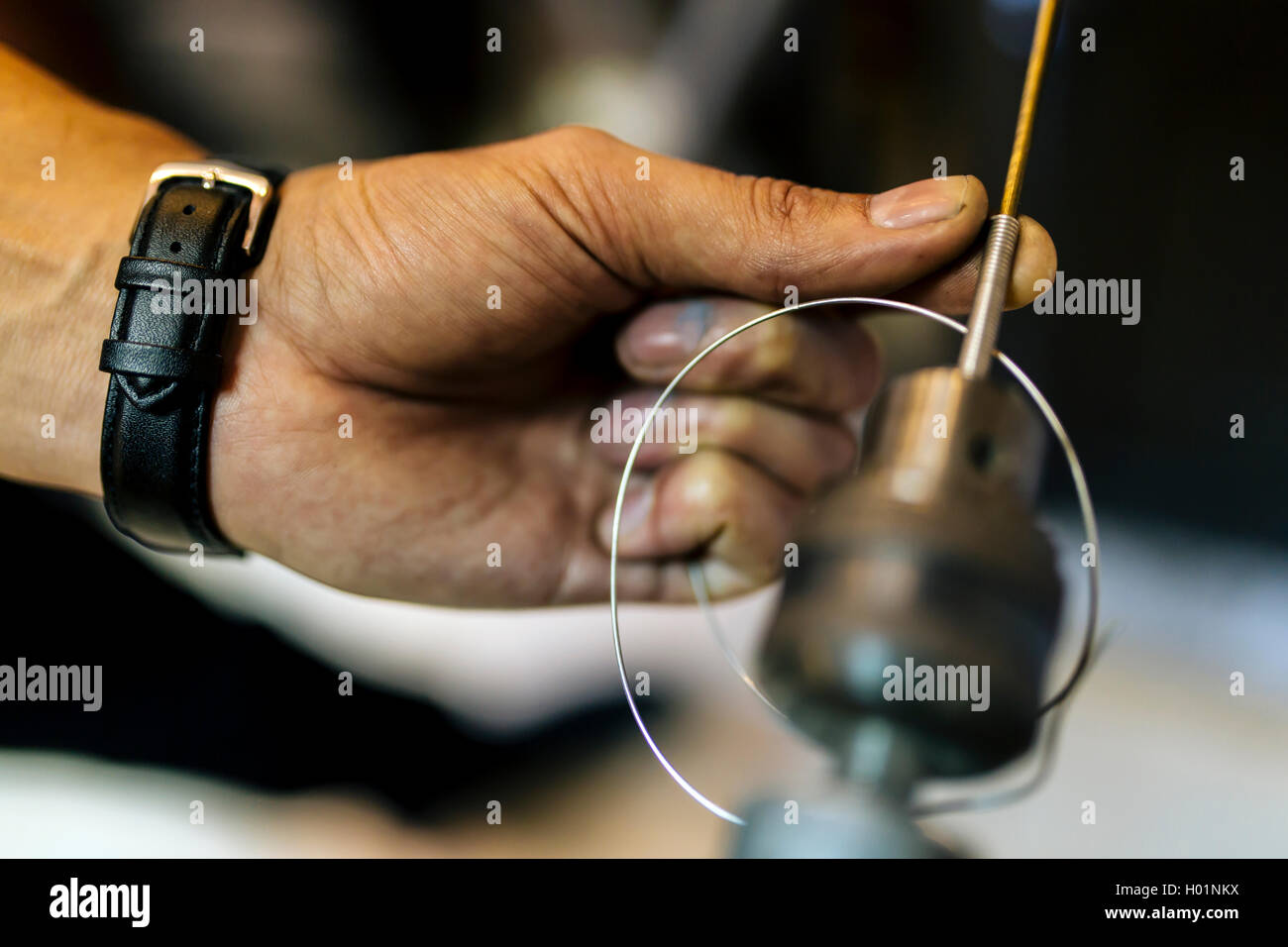 DIY, metal string wrapped around drill Stock Photo - Alamy