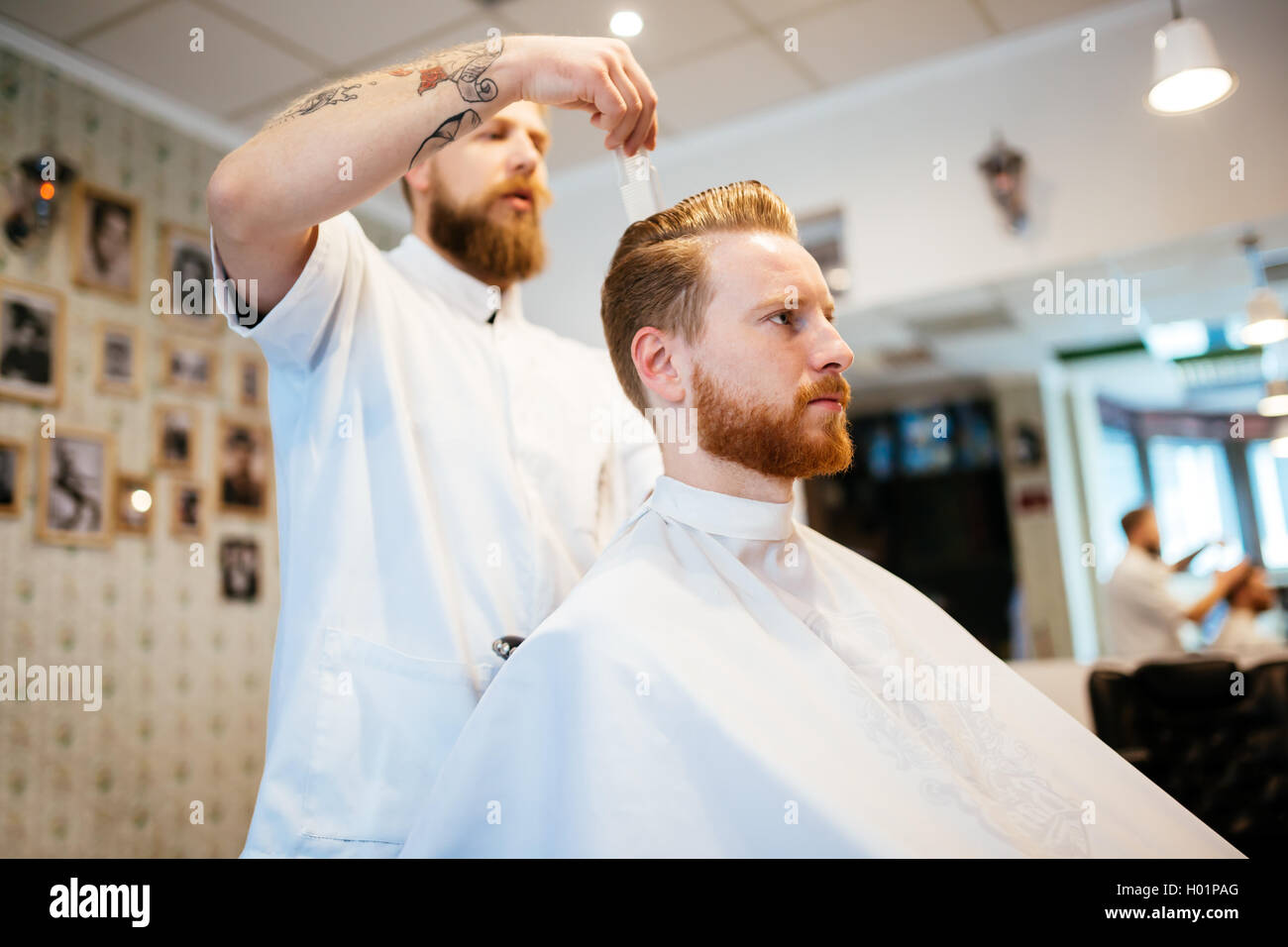 Combing of hair and styling in barber shop Stock Photo - Alamy