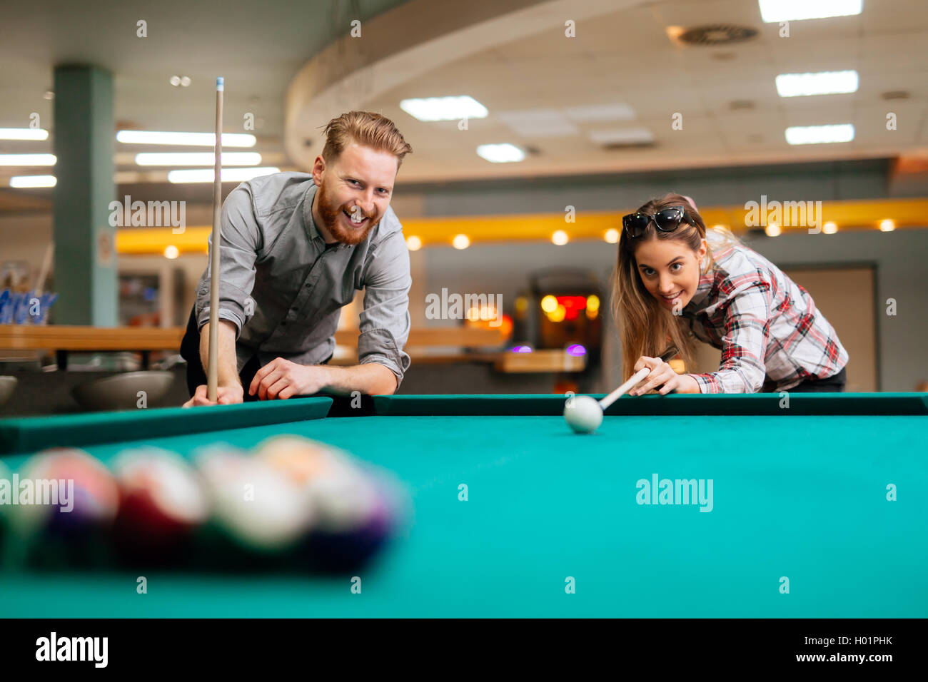 Beautiful couple dating and playing snooker Stock Photo - Alamy