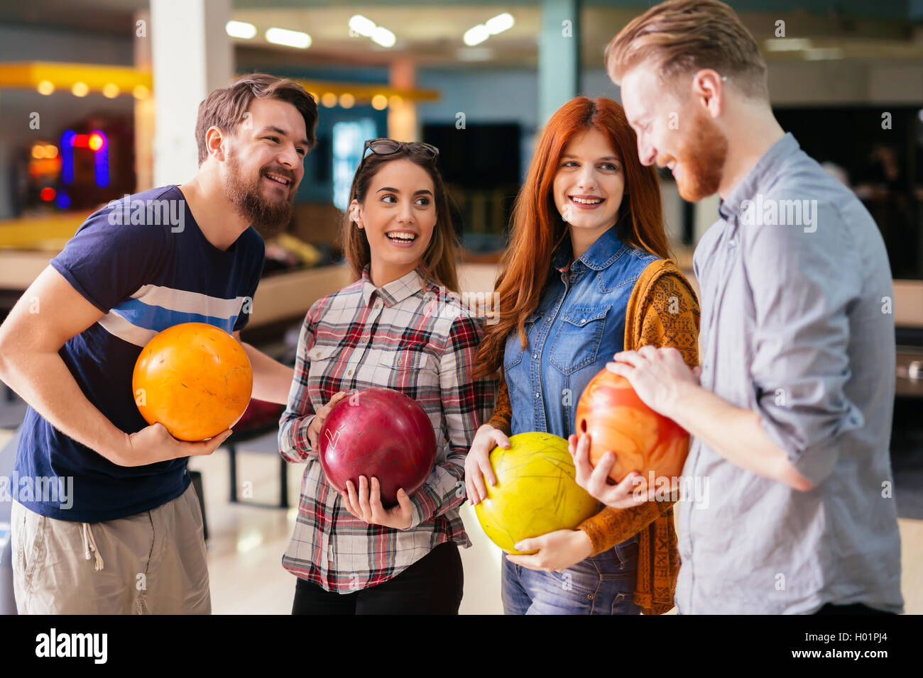 Friends having fun while bowling and speding time together Stock Photo ...