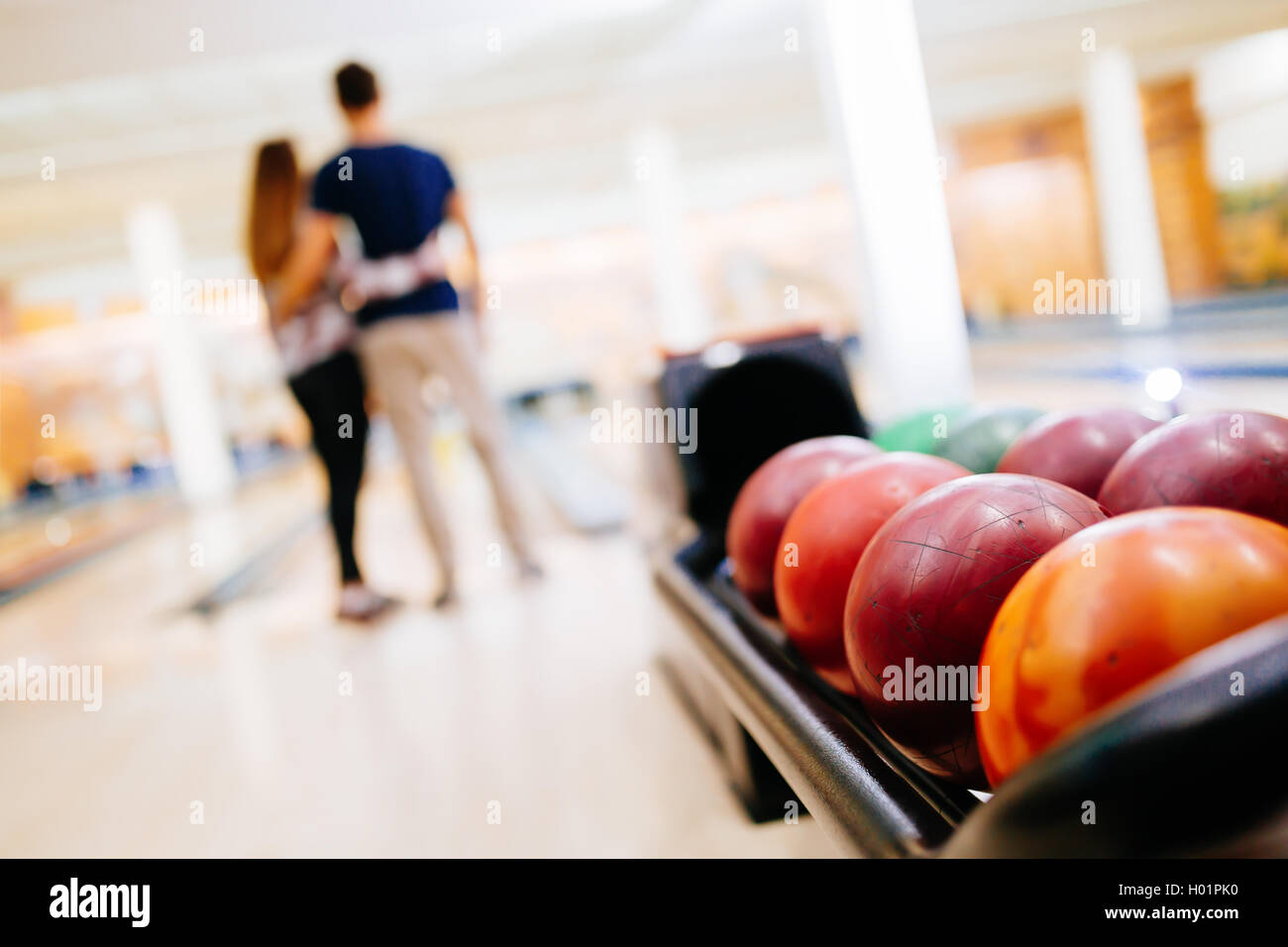 Couple enjoy bowling together and hugging Stock Photo - Alamy