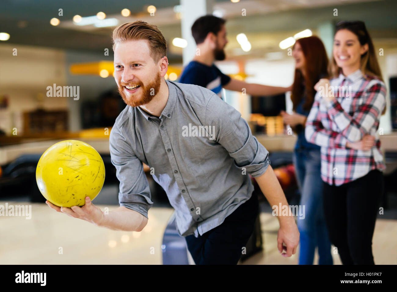 Friends bowling at club and having fun playing casually Stock Photo - Alamy