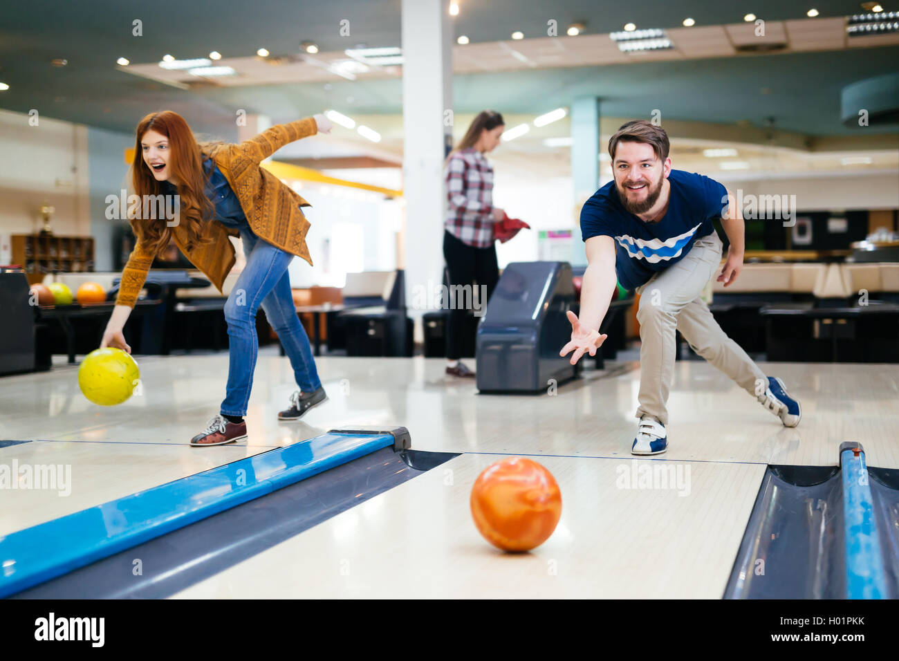 Friends enjoying recreational bowling at club Stock Photo - Alamy