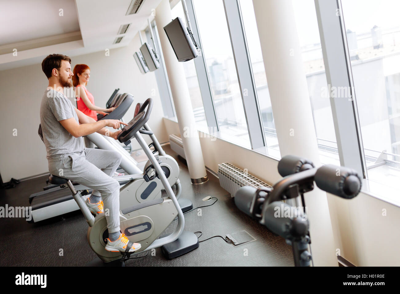 Man cardio training on a bicycle in a gym Stock Photo - Alamy