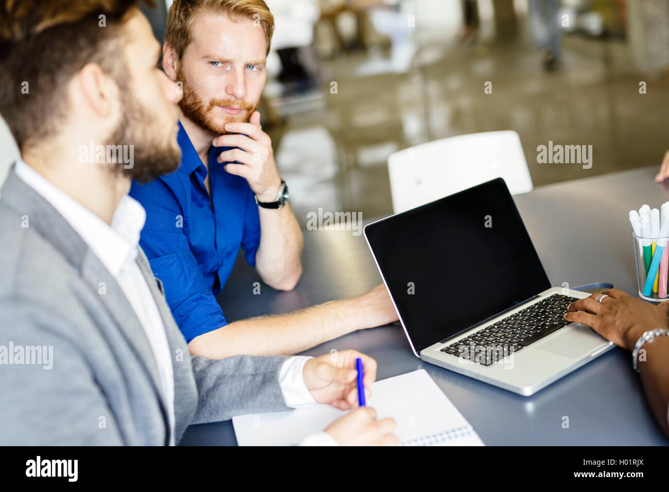 Businessmen working as a team in office Stock Photo - Alamy
