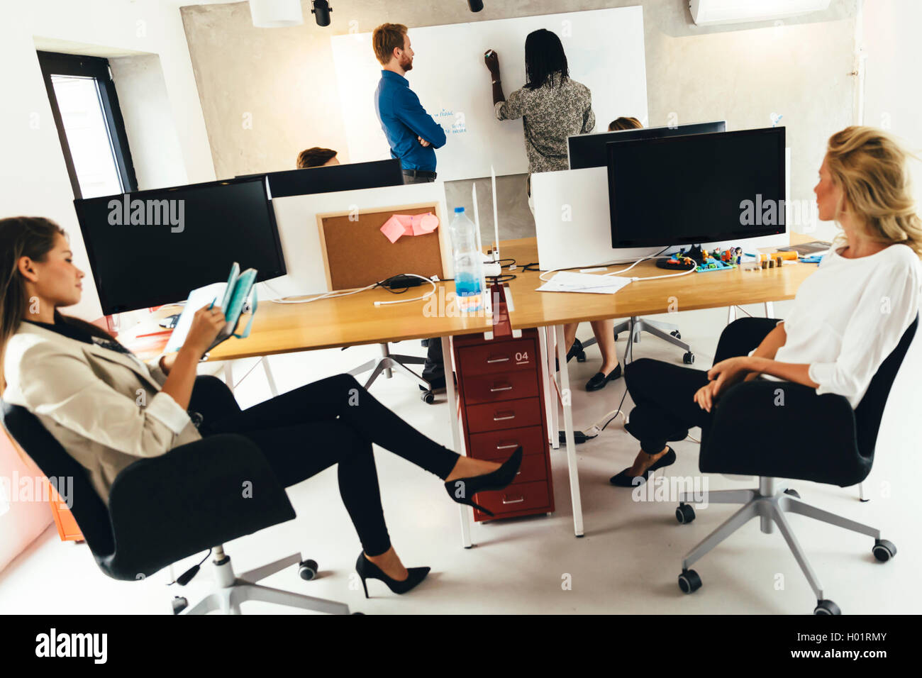 Business people at seminar improving their skills and learning new ...