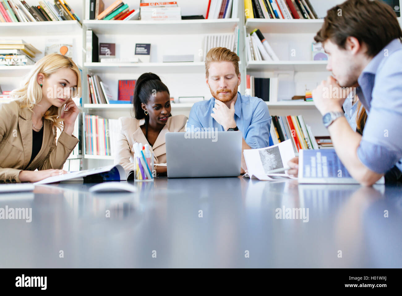 Business people collaborating in office and working on project together ...