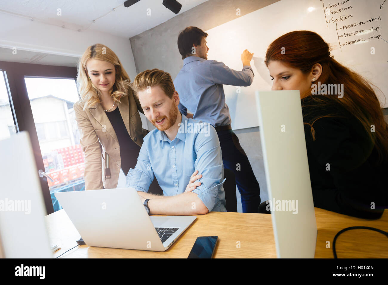 Business people collaborating in office and working on project together ...